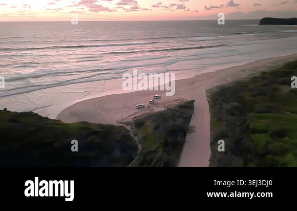 Aerial view of 4WD adventure on Fraser Island beach at dawn. High ...