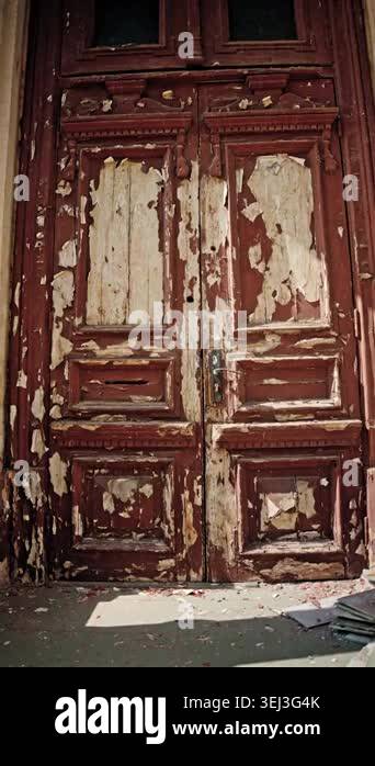 Front facing shot of a vintage wooden door with heavily peeling paint ...