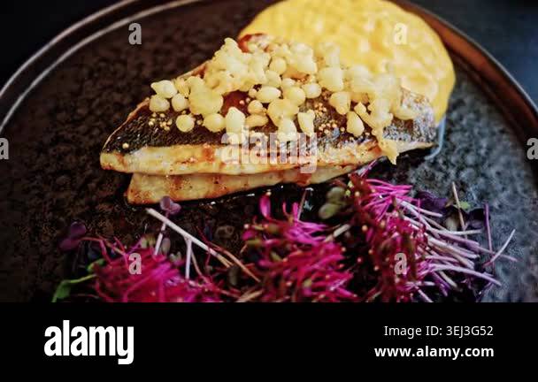 Close up of a pan seared white fish fillet with crispy skin, topped ...