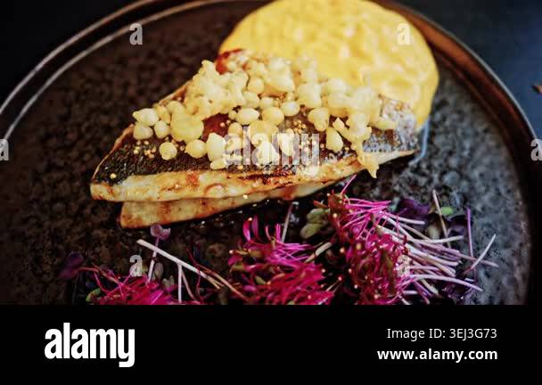 Close up of a pan seared white fish fillet with crispy skin, topped ...