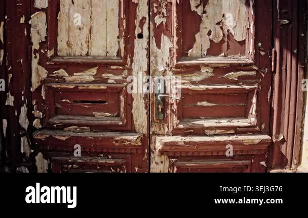 Front facing shot of a vintage wooden door with heavily peeling paint ...