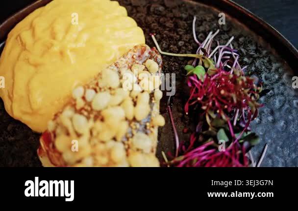 Close up of a pan seared white fish fillet with crispy skin, topped ...