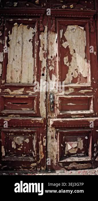 Front facing shot of a vintage wooden door with heavily peeling paint ...