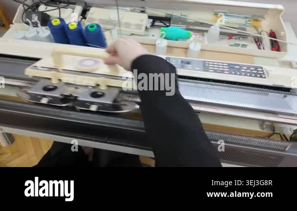 Top down view of a knitting workstation, including multiple spools of ...