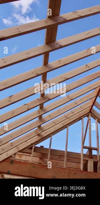 Workers construct building frame with wooden beams roof frame trusses ...