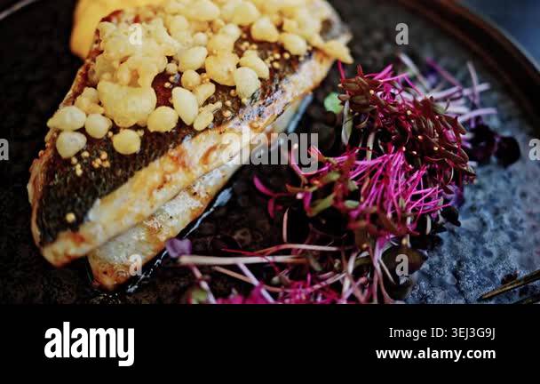 Close up of a pan seared white fish fillet with crispy skin, topped ...