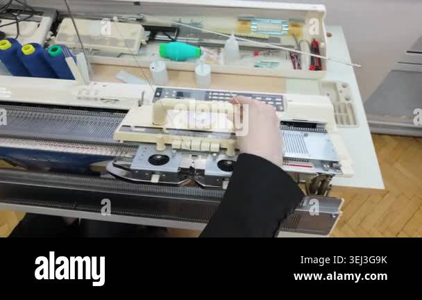 Top down view of a knitting workstation, including multiple spools of ...