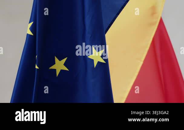 European Union and Moldova flags waving in the wind outside a building ...