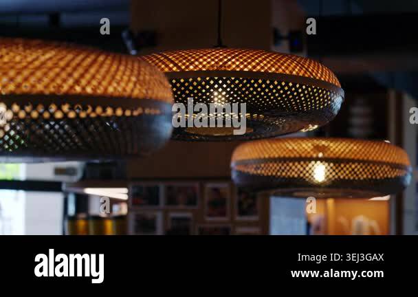 Stylish decorative hanging lamp glowing warmly in a modern interior ...