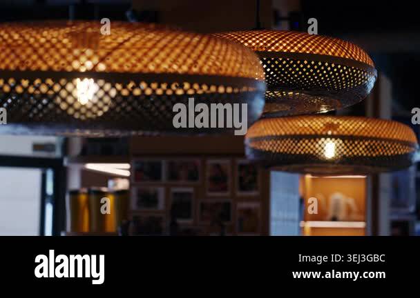 Stylish decorative hanging lamp glowing warmly in a modern interior ...