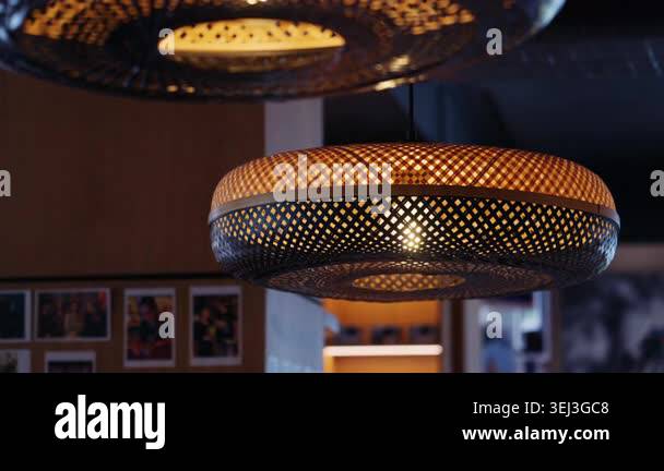 Stylish decorative hanging lamp glowing warmly in a modern interior ...