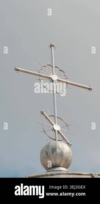 Metal cross on top of a church against a clear sky Stock Video Footage ...