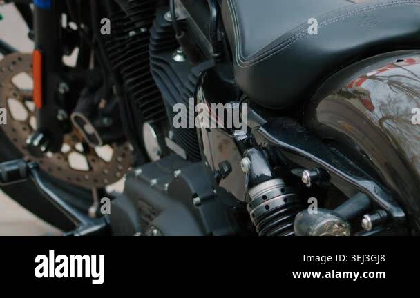 Close up of a black motorcycle engine, rear suspension, and glossy body ...