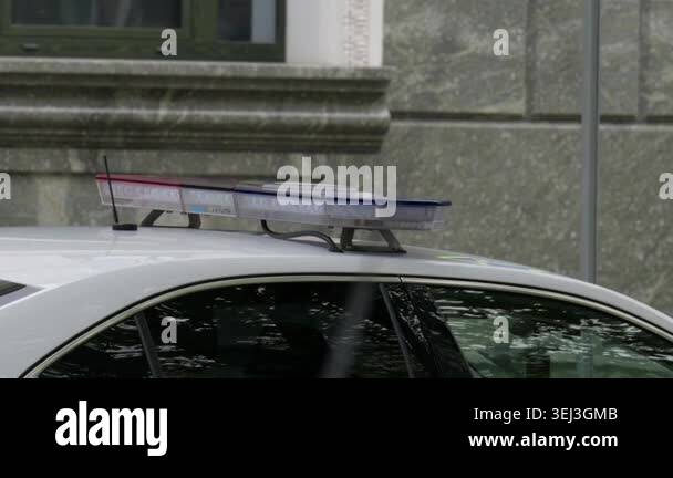 Close up of flashing red and blue emergency lights on top of a police ...