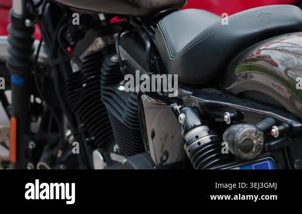 Close up of a black motorcycle engine, rear suspension, and glossy body ...