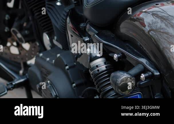Close up of a black motorcycle engine, rear suspension, and glossy body ...