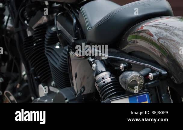Close up of a black motorcycle engine, rear suspension, and glossy body ...