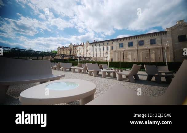 Low angle view of outdoor lounge chairs and tables at winery castle in ...