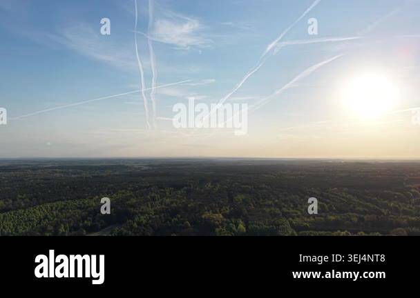 Blue sky filled with white aircraft trail lines Stock Video Footage - Alamy