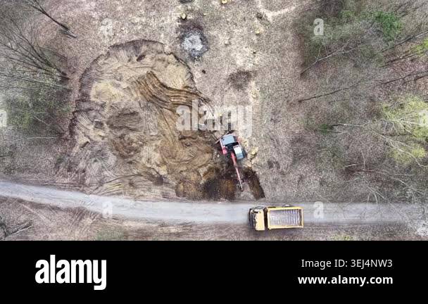 Heavy equipment performing earthmoving in a natural environment Stock ...