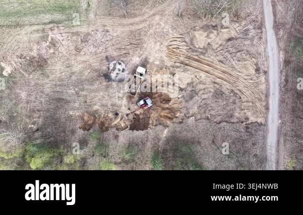 Excavator loading dirt into a dump truck Stock Video Footage - Alamy