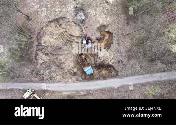 Forest road construction with an excavator and trucks Stock Video ...