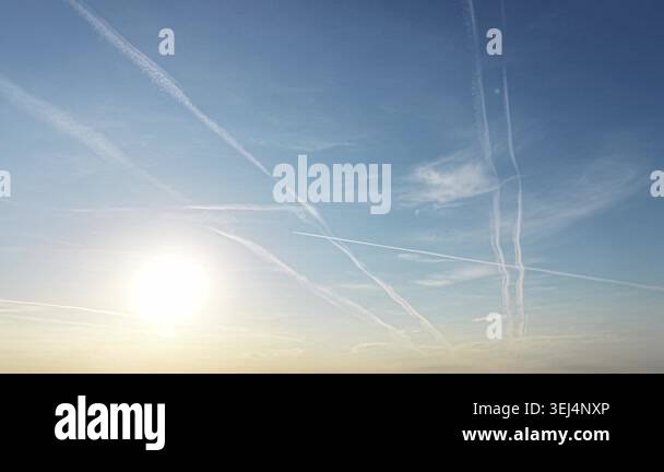 Bright morning sky with crossing airplane vapor trails Stock Video ...
