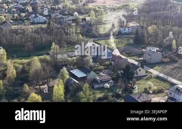 Aerial view of homes surrounded by trees and fog Stock Video Footage ...