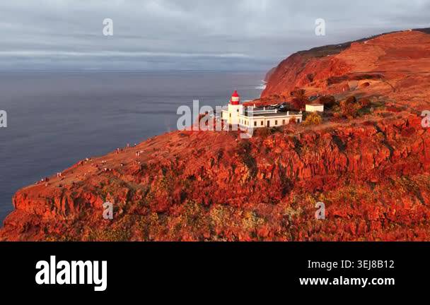 Golden light illuminates Ponta do Pargo Lighthouse on dramatic ocean ...