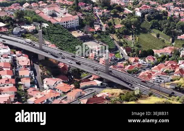 Aerial view shows a modern cable stayed bridge with cars driving in ...