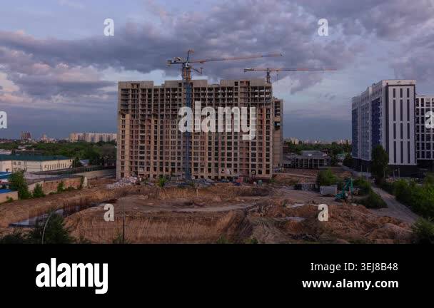 Residential apartment building under construction with tower cranes at ...