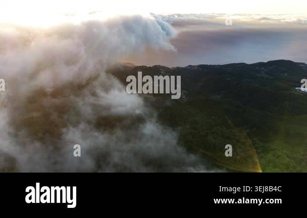 Clouds dramatically flow over green mountains in Madeira Portugal ...
