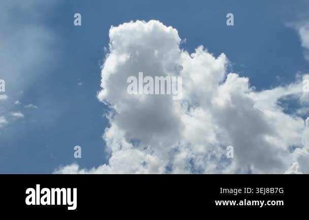 Smooth footage of cumulus clouds drifting across the sky, creating a ...