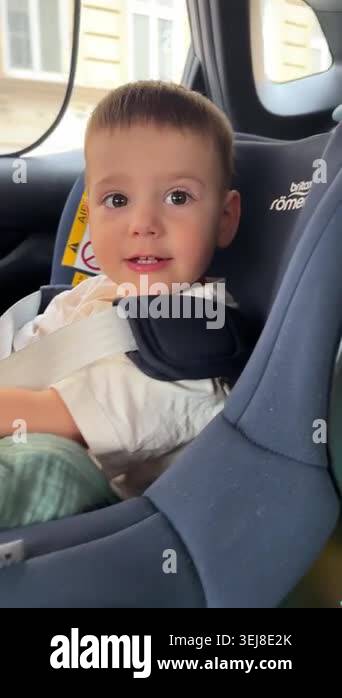 Smiling toddler in a safe car seat Close up Stock Video Footage - Alamy