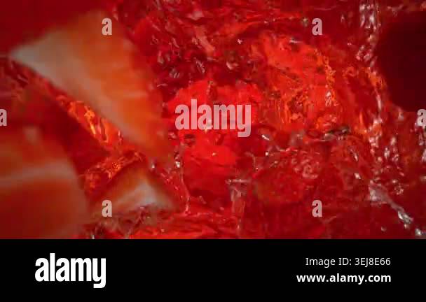 Super Slow Motion Shot of Fresh Strawberries and Ice Falling into Water ...