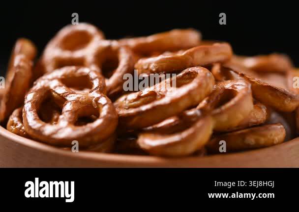 Rotating bowl of pretzels on table close up snack food concept Stock ...