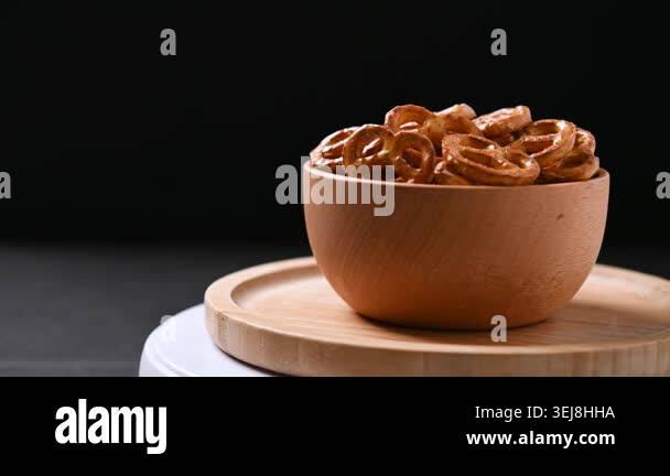 Rotating bowl of pretzels on table close up snack food concept Stock ...