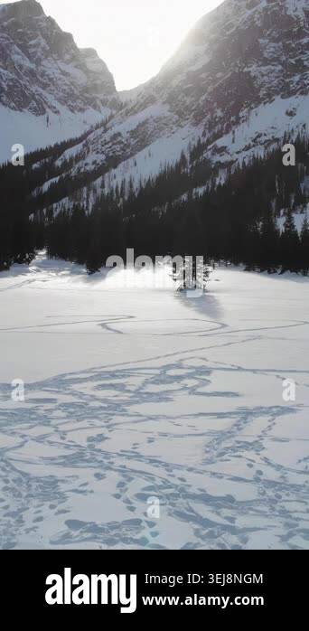 Frozen Lake Sunrise With Mountains, Lone Walker Crossing Icy Surface ...