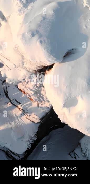 Overhead Drone Of Snow Cornice, Golden Hour Sunlight Sculpting Cratered ...
