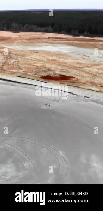Aerial View Expansive Salt Flat And Emerald Pool Near Distant Treeline ...