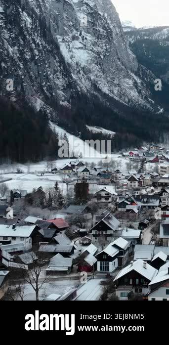 Valley Town Cradled By Towering Cliffs With Snowrimmed Peaks, Broad ...