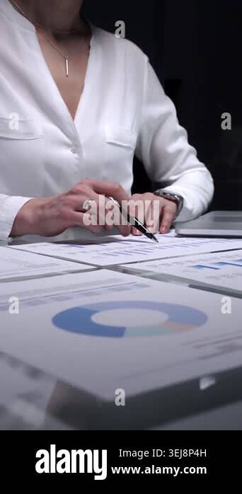 Businesswoman conducting detailed audit checking financial spreadsheets ...
