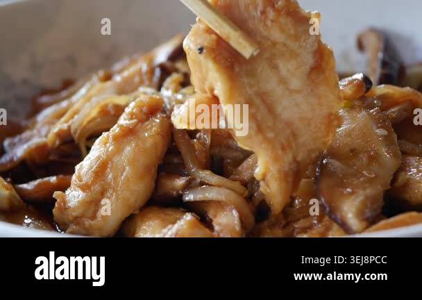 Cooked chicken pieces mixed with vegetables and sauce in a bowl Stock ...