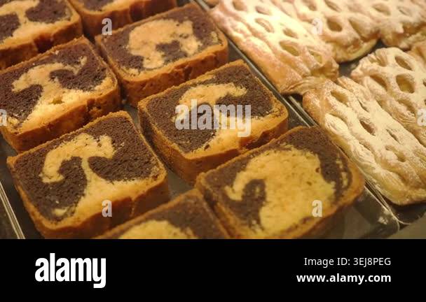 Different types of baked goods are arranged for sale in a shop Stock ...