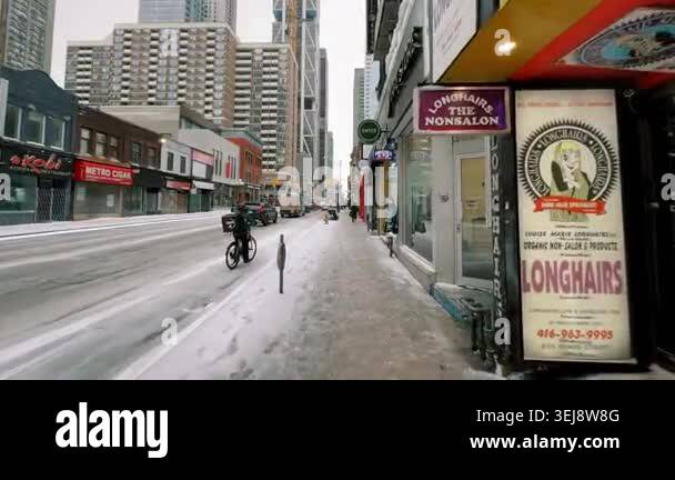 Shopper Stepping Onto Icy Downtown Sidewalk Past Red Storefronts, Bike ...
