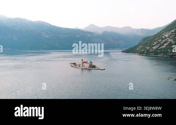 Church island near Perast bay stone chapel with red roof surrounded by ...