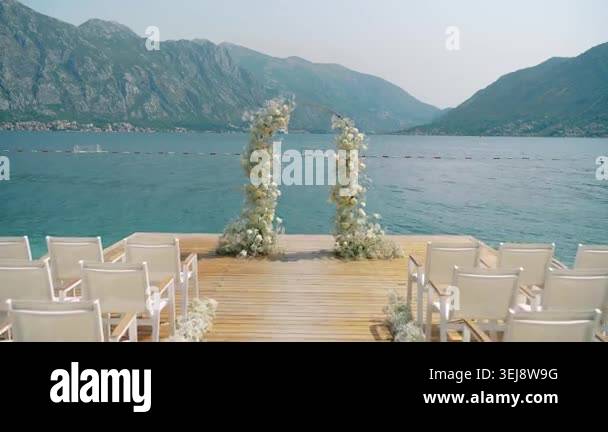 Sunlit pier arch with mountain backdrop, airy turquoise sea and neat ...