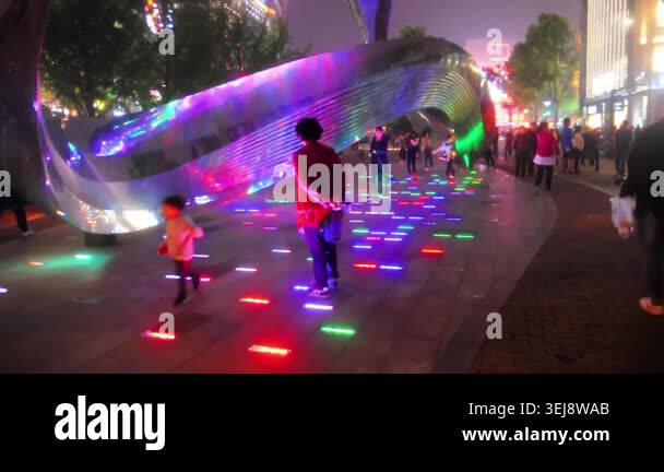 China, Wuhan - March 10, 2019: People enjoy illuminated light in public ...