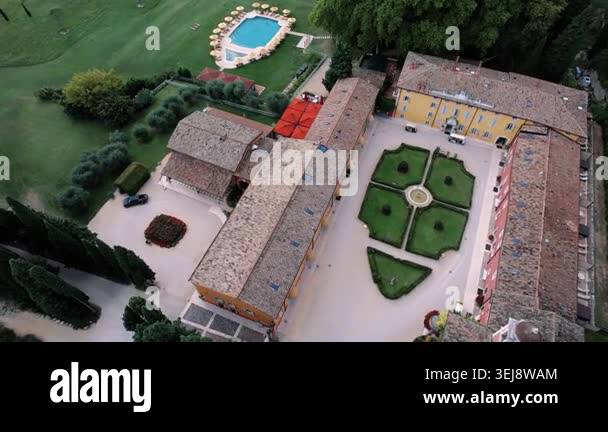 Aerial poolside villa with parterre garden, sun umbrellas, gravel ...