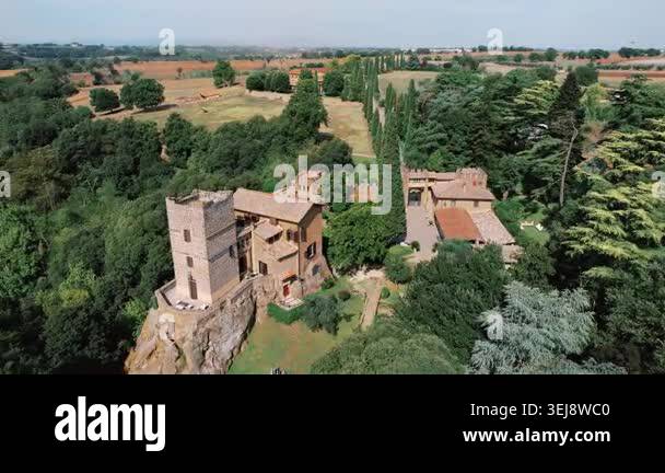 Stone tower and medieval houses perched on tuscany hill with panoramic ...